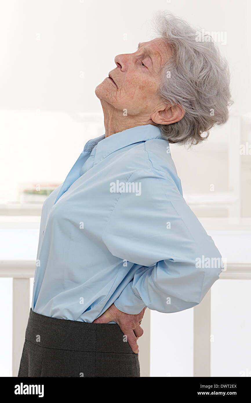 Lower back pain in elderly person Stock Photo - Alamy