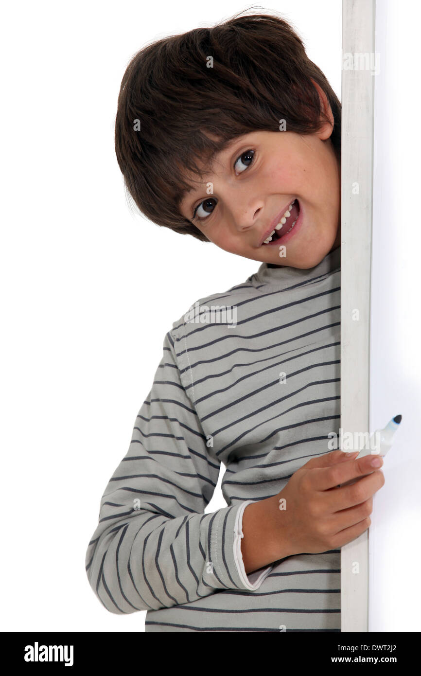 Little boy hiding in studio Stock Photo - Alamy