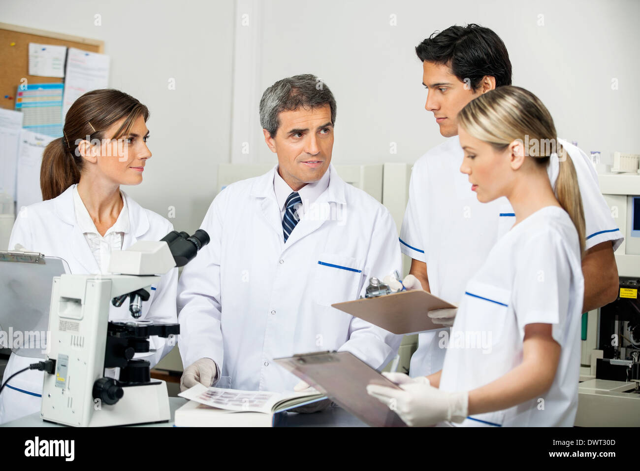 Scientist With Students Taking Notes In Laboratory Stock Photo - Alamy