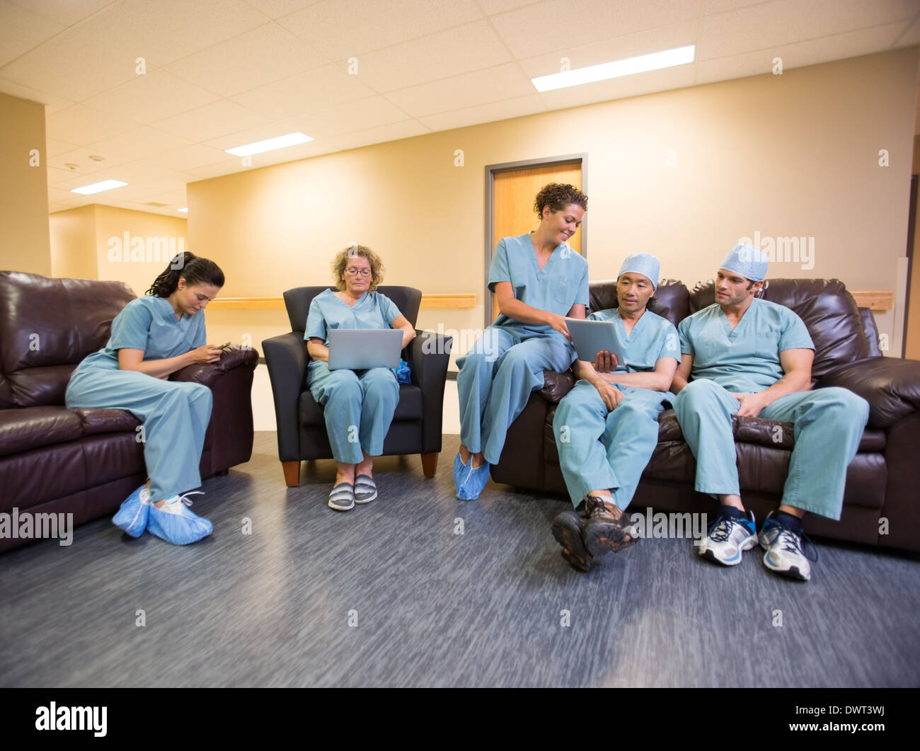 Medical Team Using Technologies In Hospital's Waiting Room Stock Photo ...