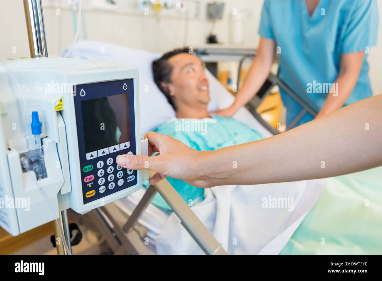 Nurse's Hand Operating IV Machine While Patient In Background Stock ...