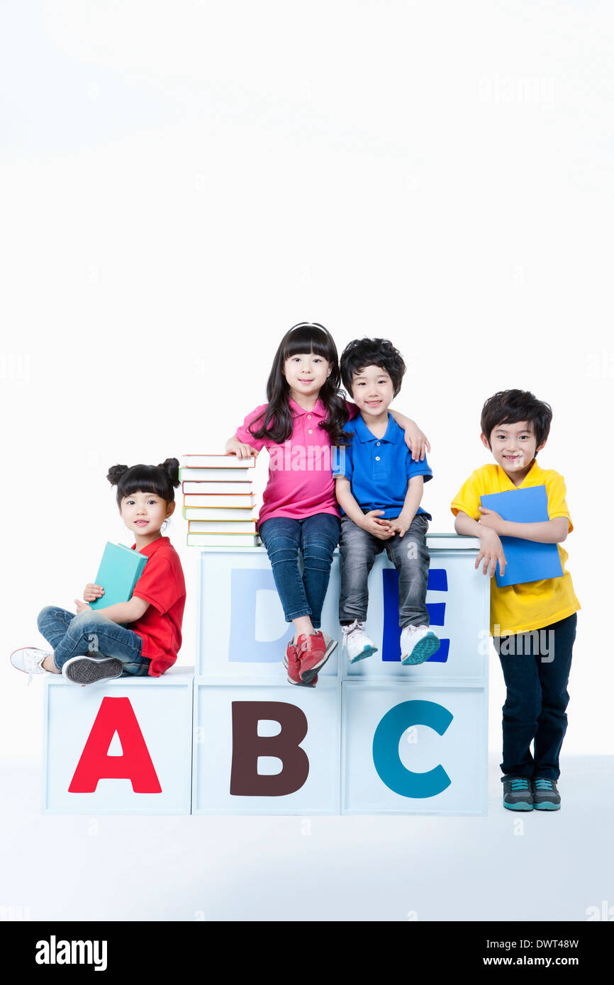 Kids sitting on alphabet blocks hi-res stock photography and images - Alamy