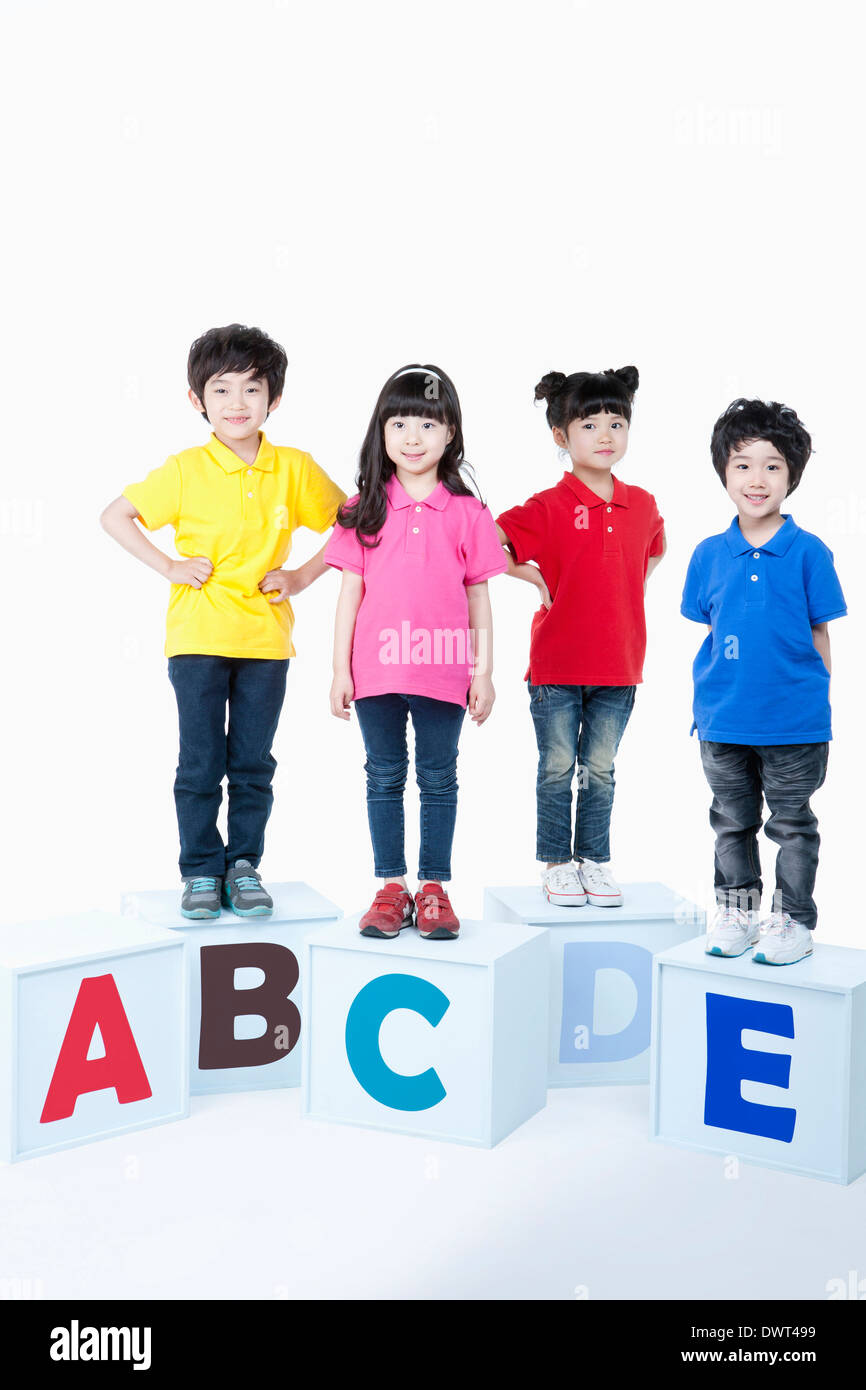 kids standing on alphabet blocks Stock Photo - Alamy