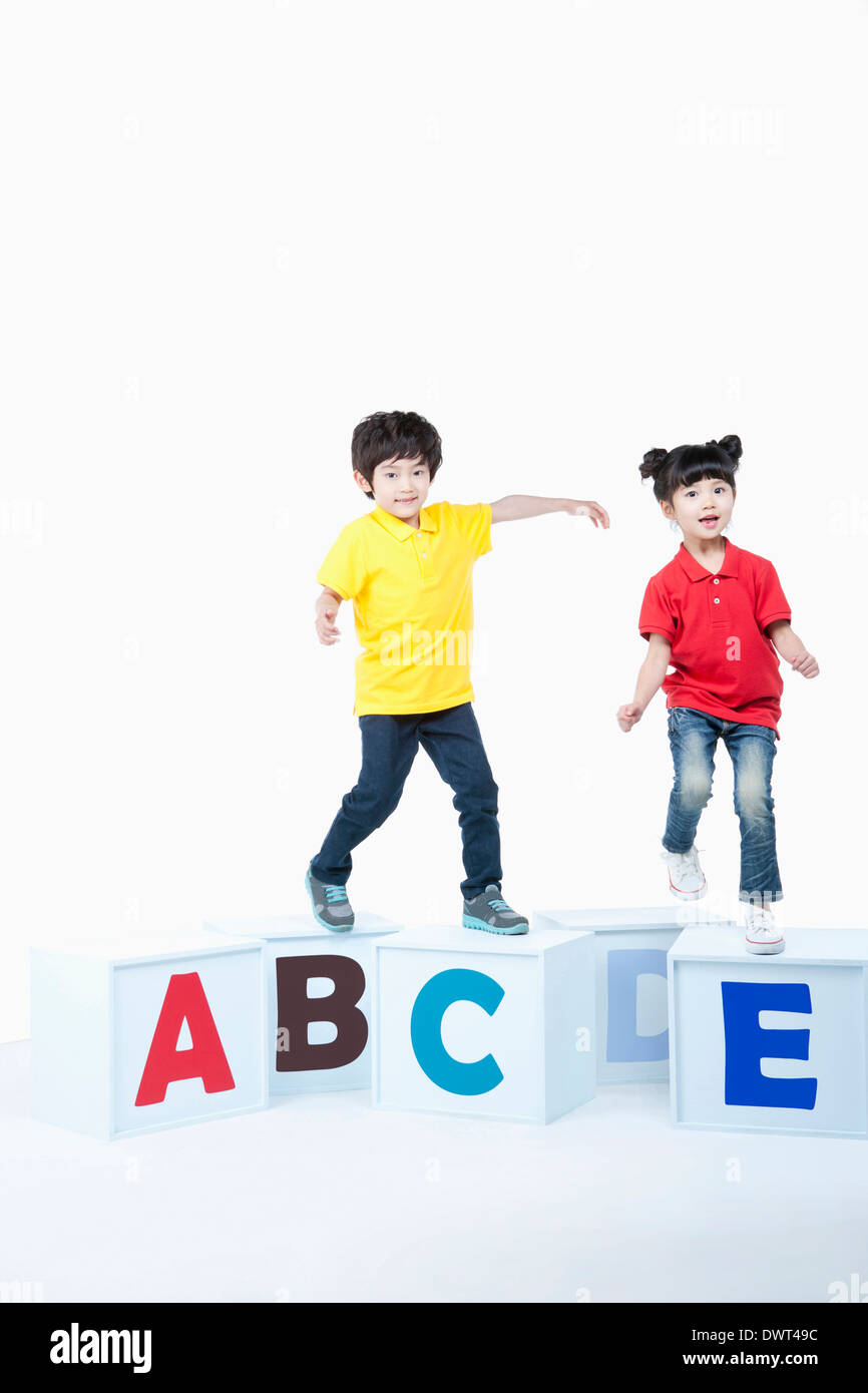kids playing on alphabet blocks Stock Photo - Alamy