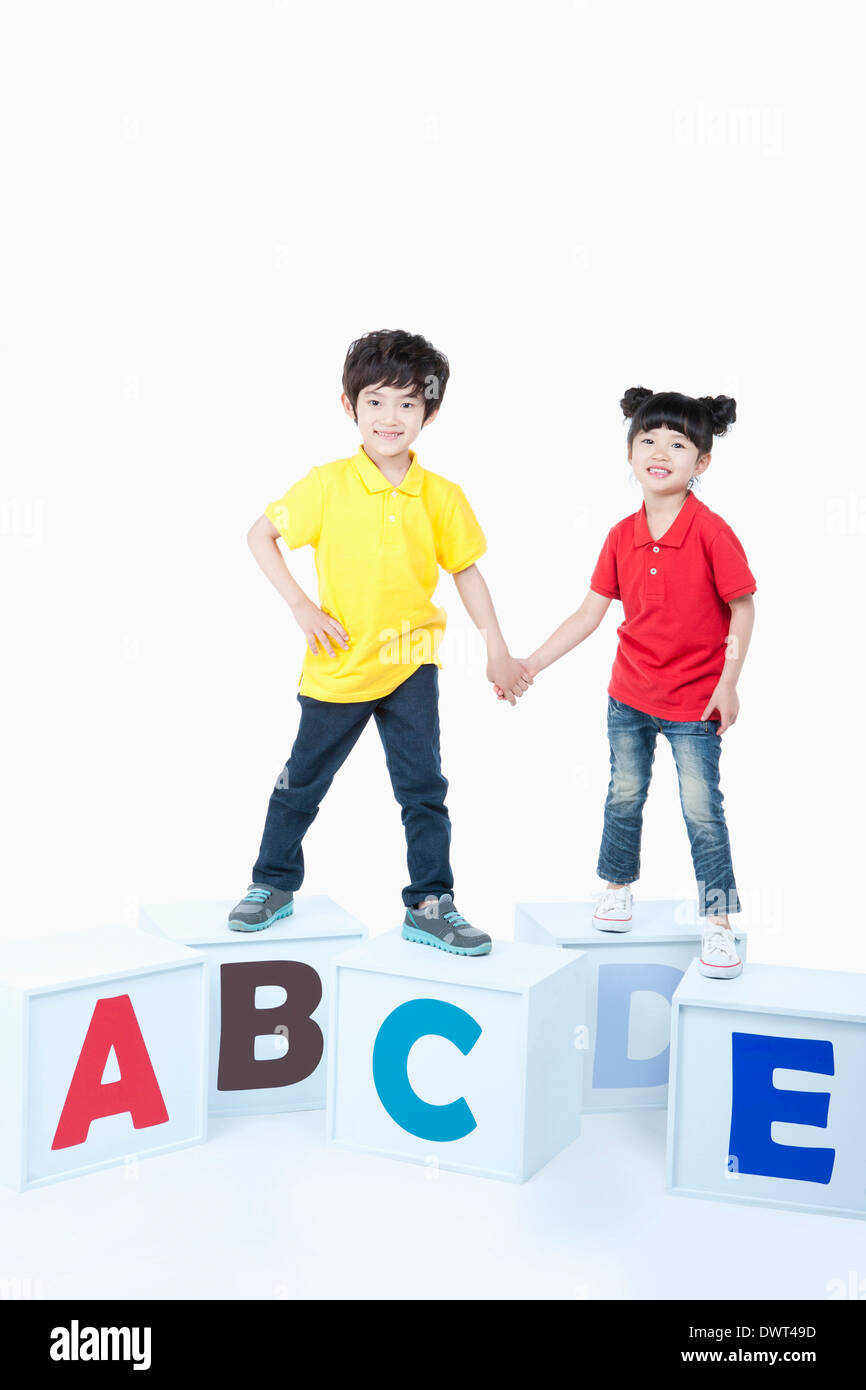 kids playing on alphabet blocks Stock Photo - Alamy