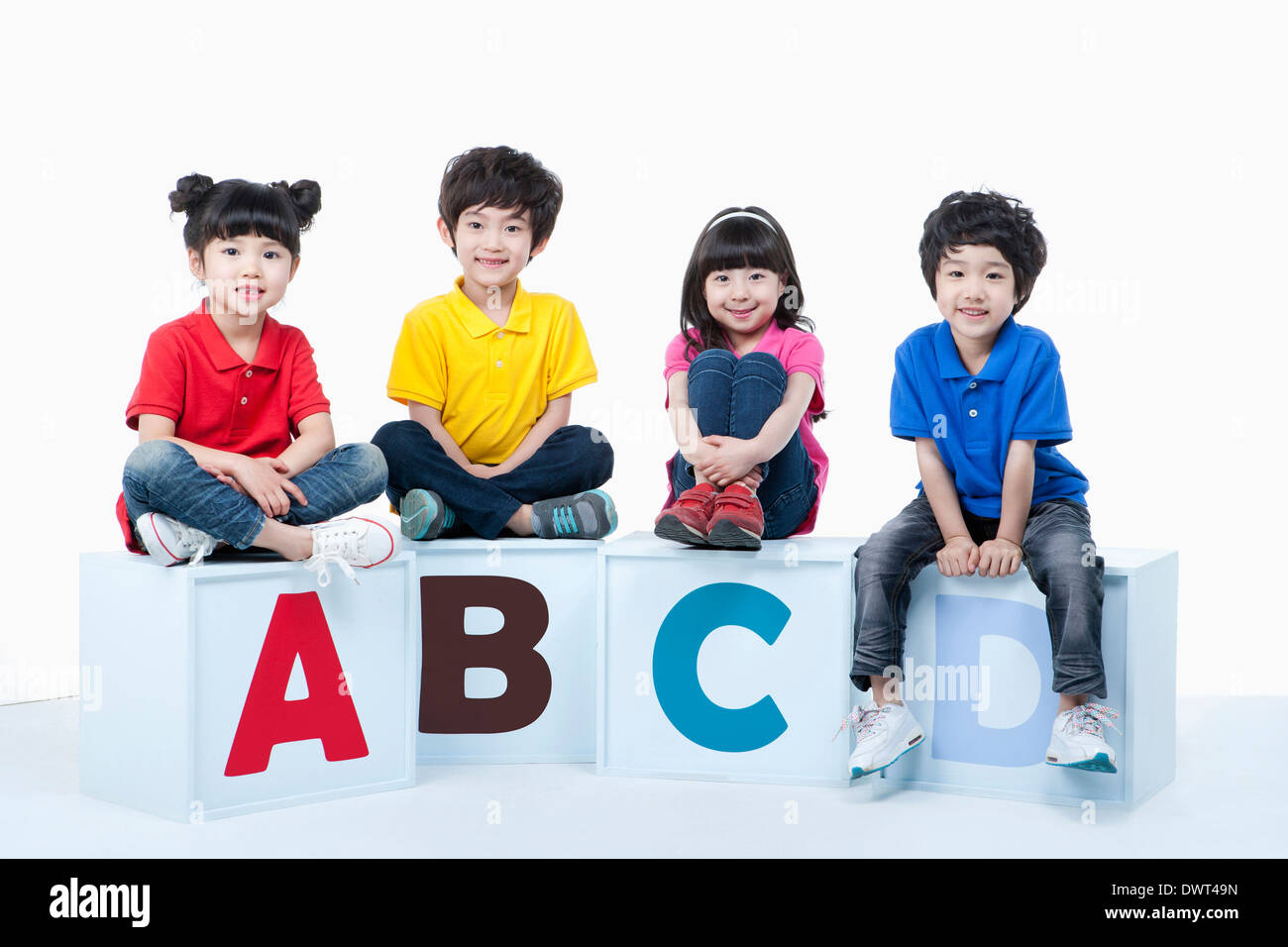 kids sitting on alphabet blocks Stock Photo - Alamy