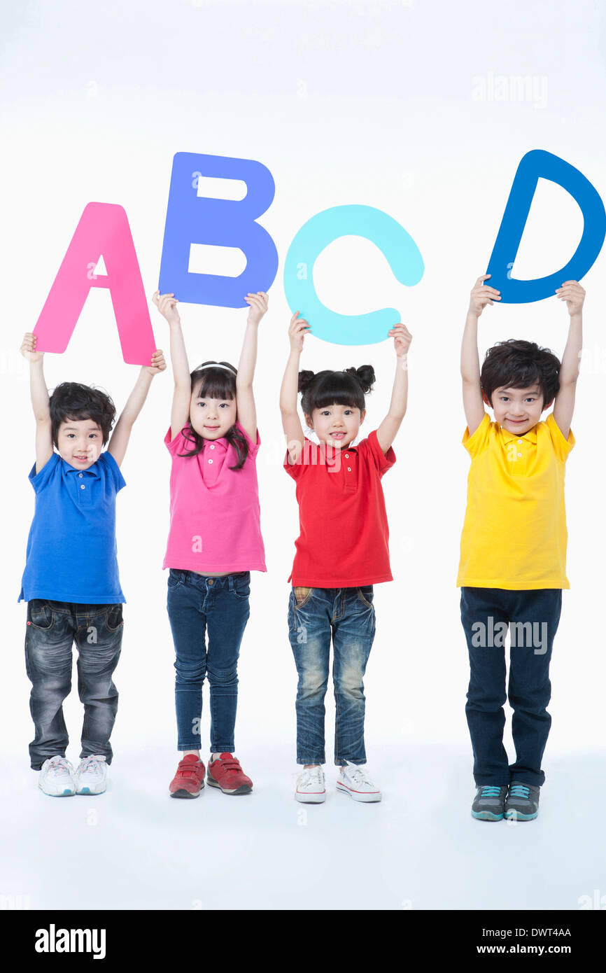 kids holding alphabet letters up in the air Stock Photo - Alamy
