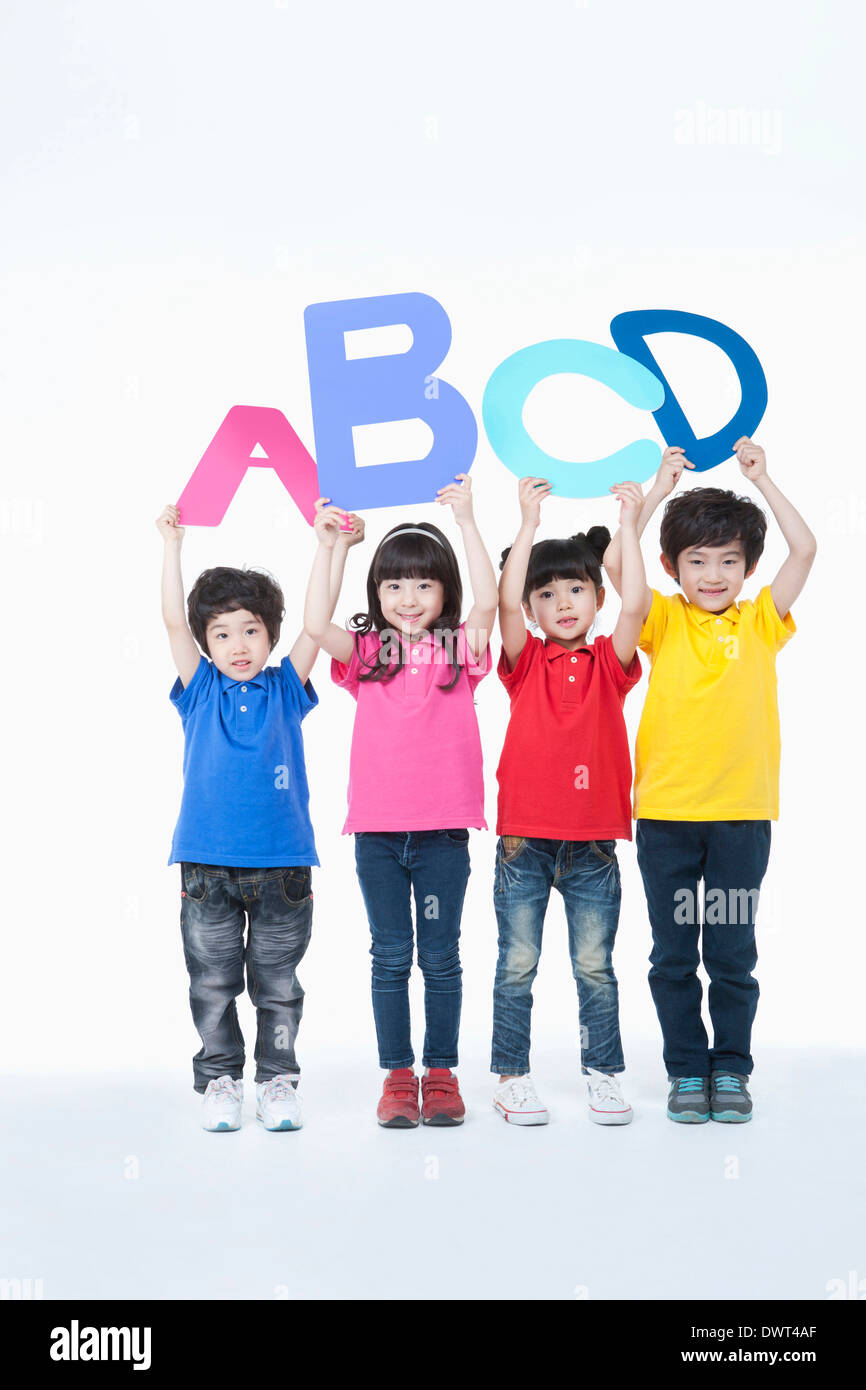 Children holding alphabet letters hi-res stock photography and images ...
