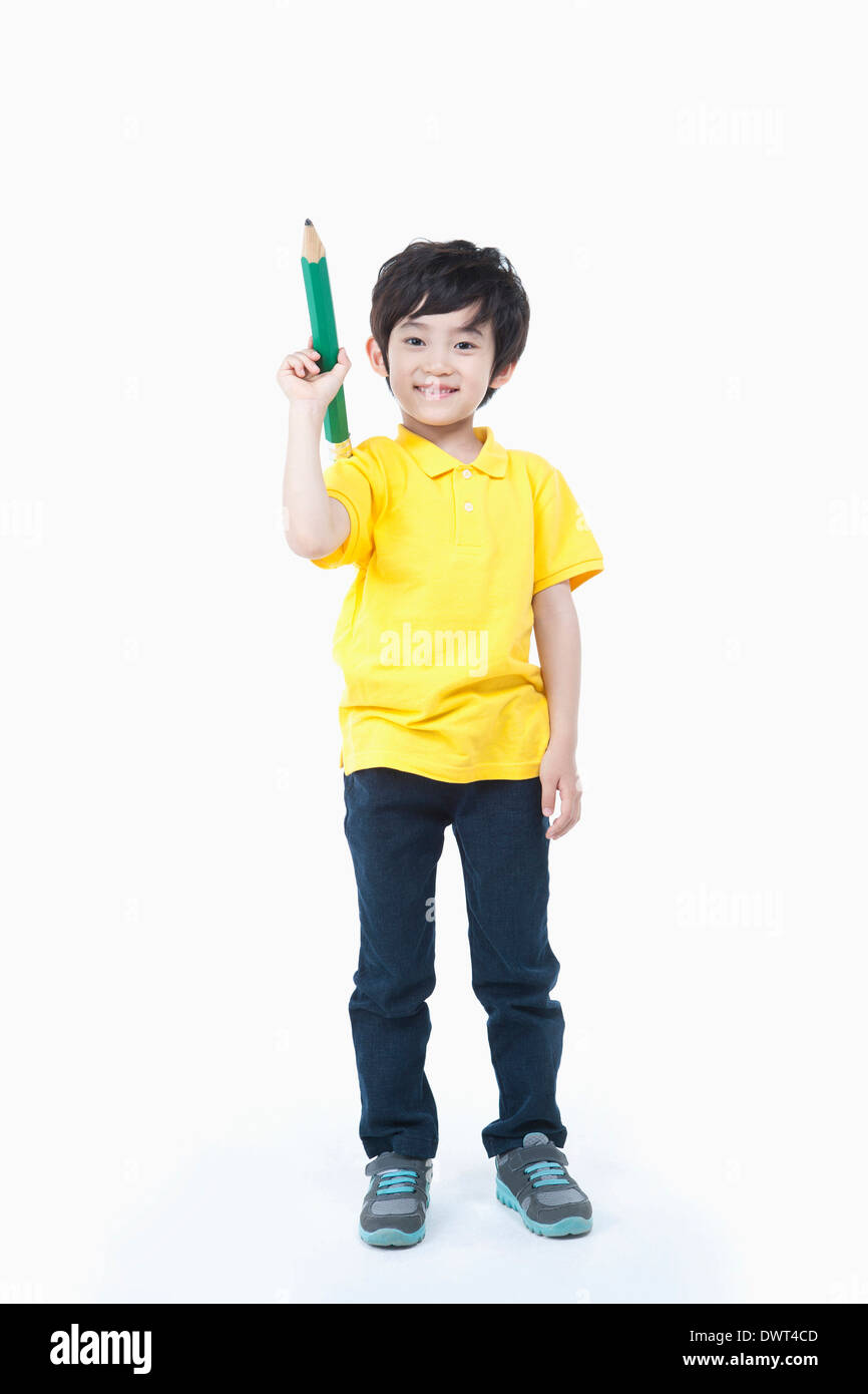 a kid standing on a pile of books holding a pen Stock Photo - Alamy