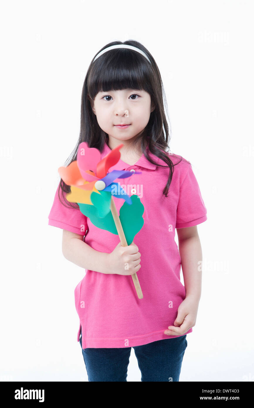 a kid holding paper pin wheel Stock Photo - Alamy