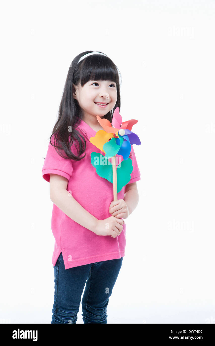 a kid holding paper pin wheel Stock Photo - Alamy