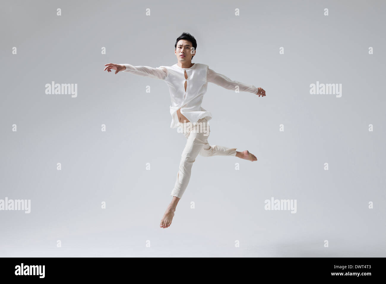 a man wearing white making dance poses Stock Photo - Alamy