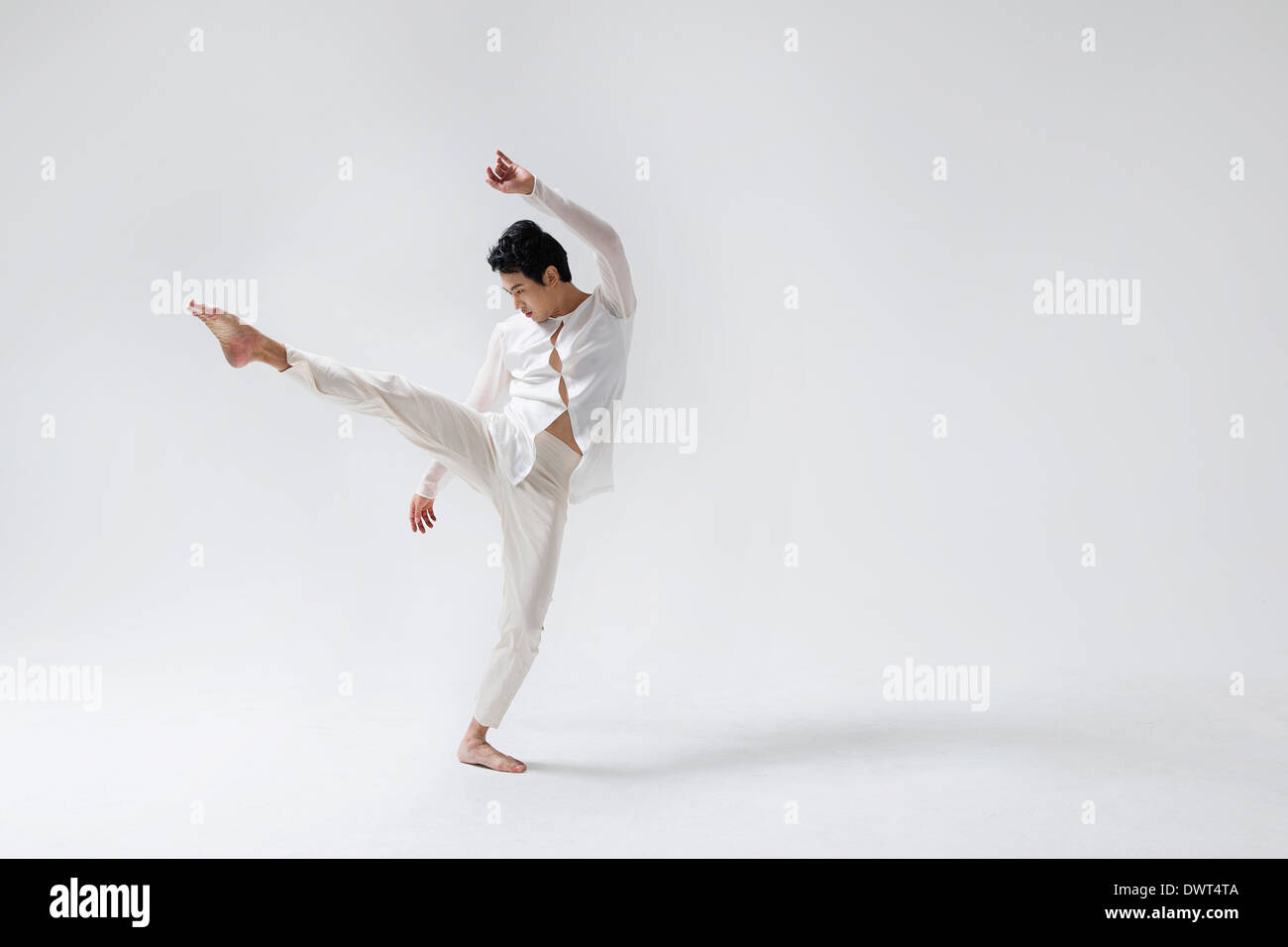 a man wearing white making dance poses Stock Photo - Alamy