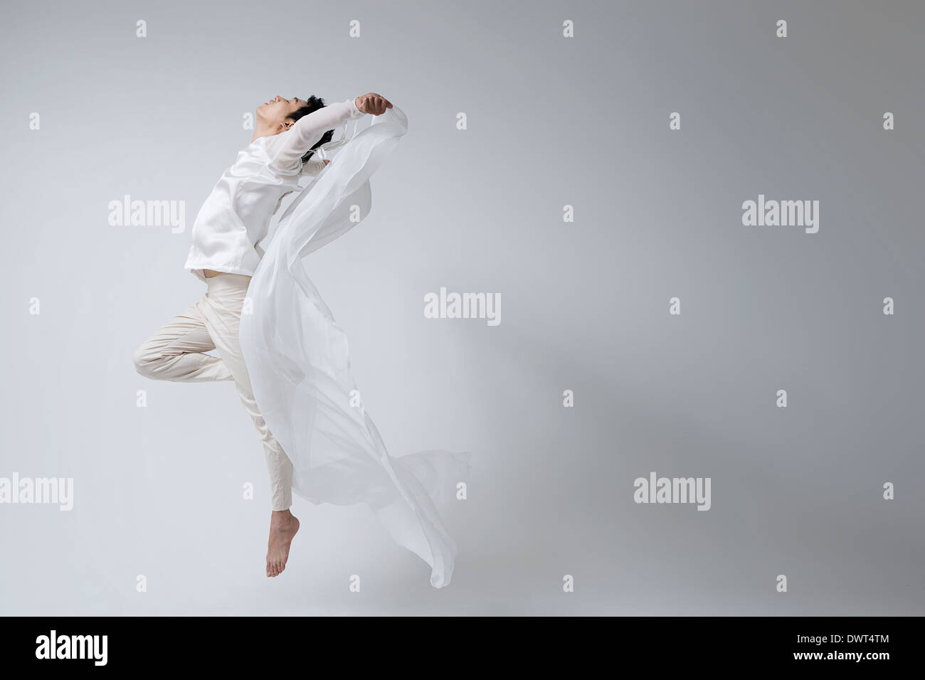 a man wearing white making dance poses Stock Photo - Alamy