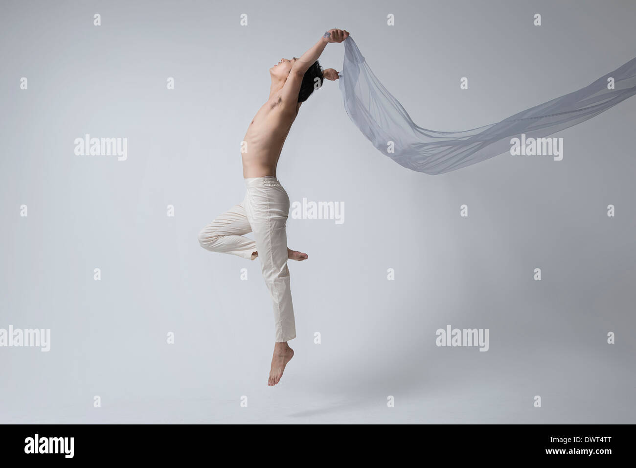 a man wearing white making dance poses Stock Photo - Alamy