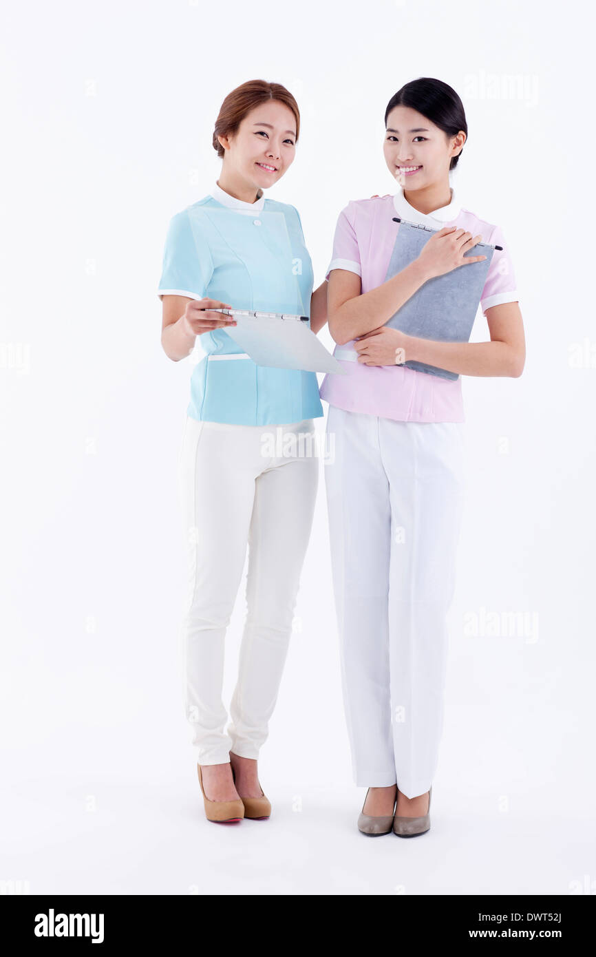 two nurses posing with patient charts Stock Photo - Alamy