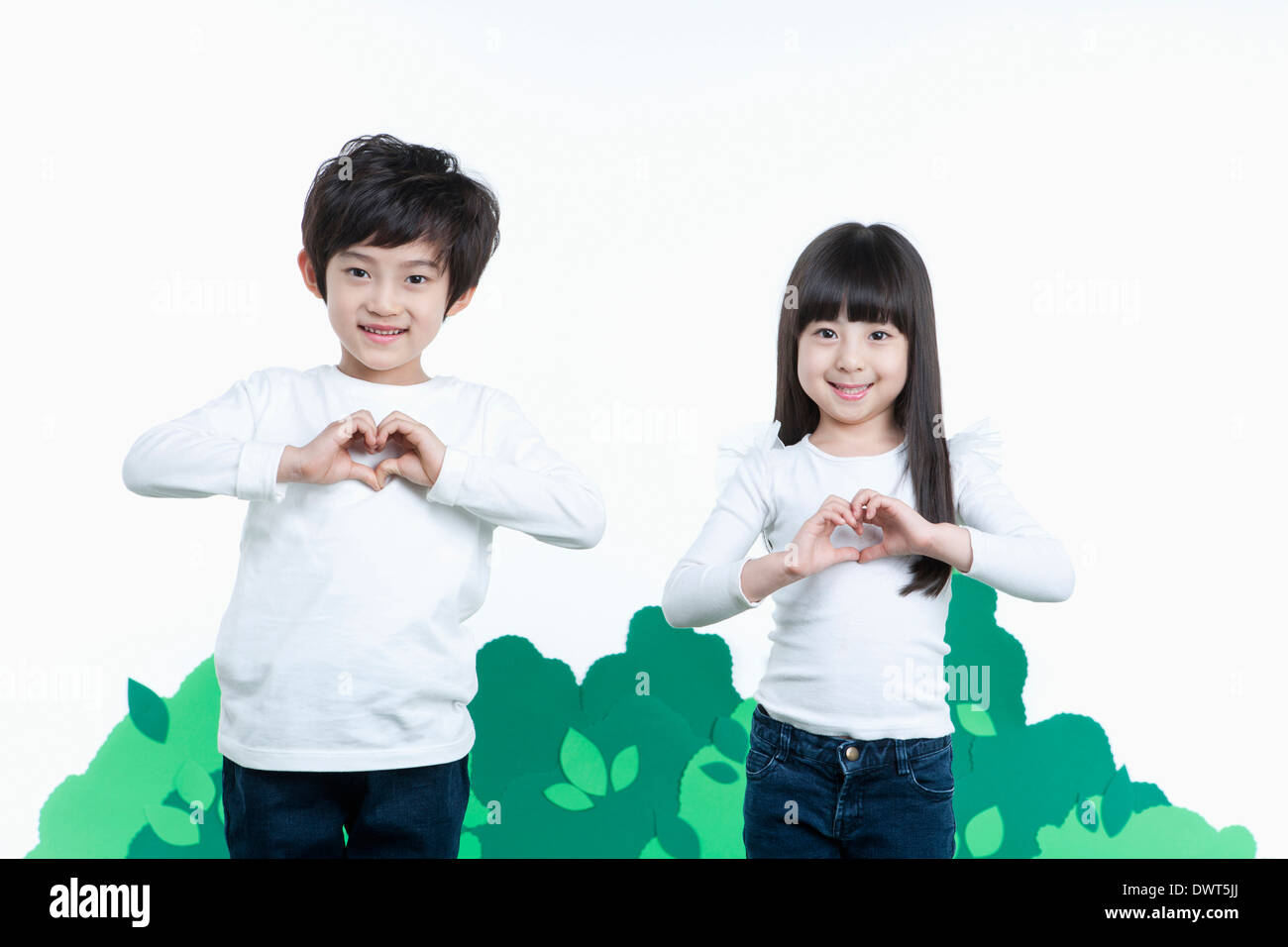 a boy and a girl making heart signs Stock Photo - Alamy
