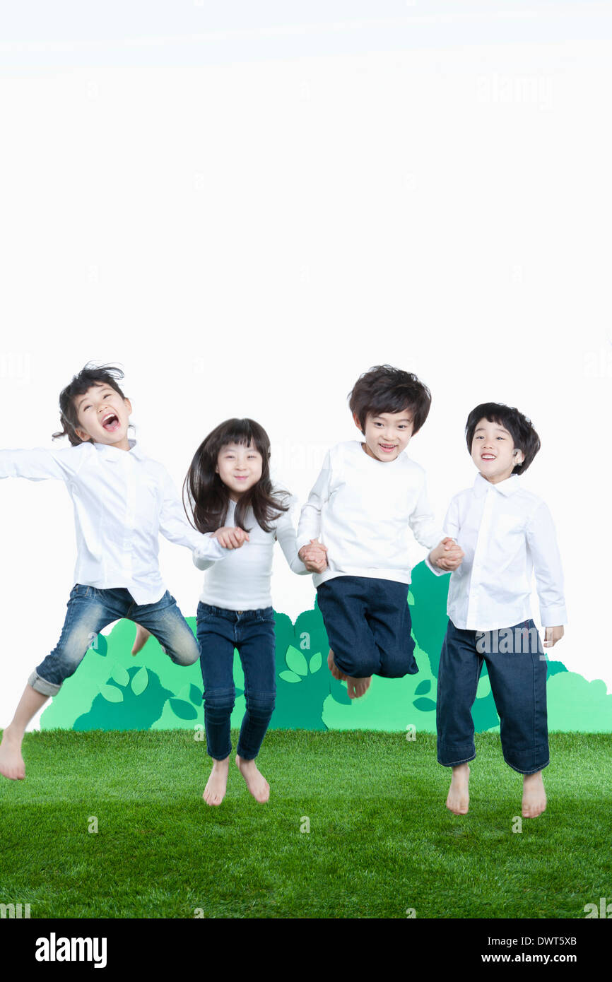 four children playing on grass Stock Photo - Alamy