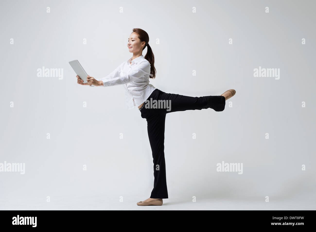 a woman making dance poses with a laptop Stock Photo - Alamy
