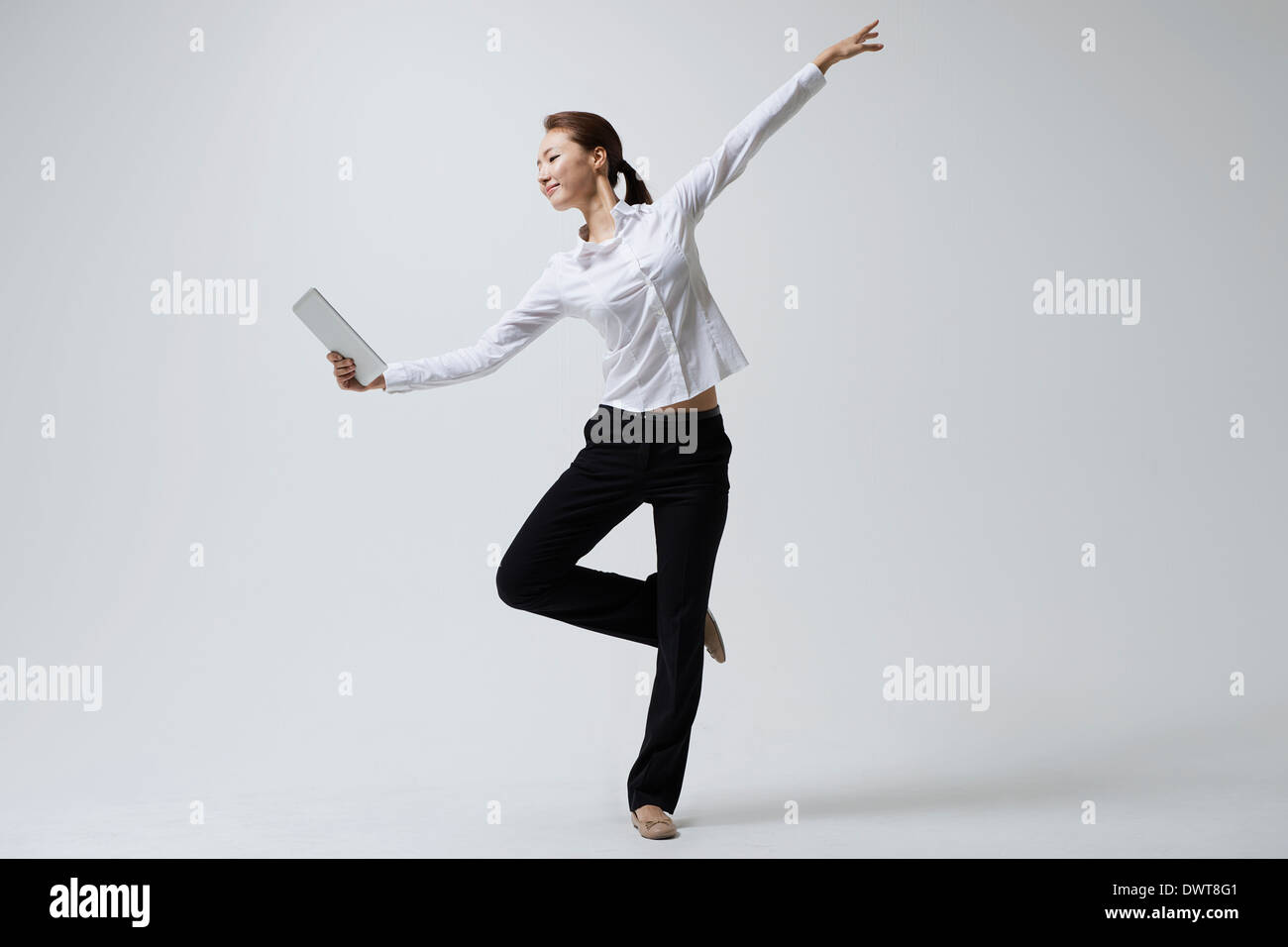 a woman making dance poses with a laptop Stock Photo - Alamy
