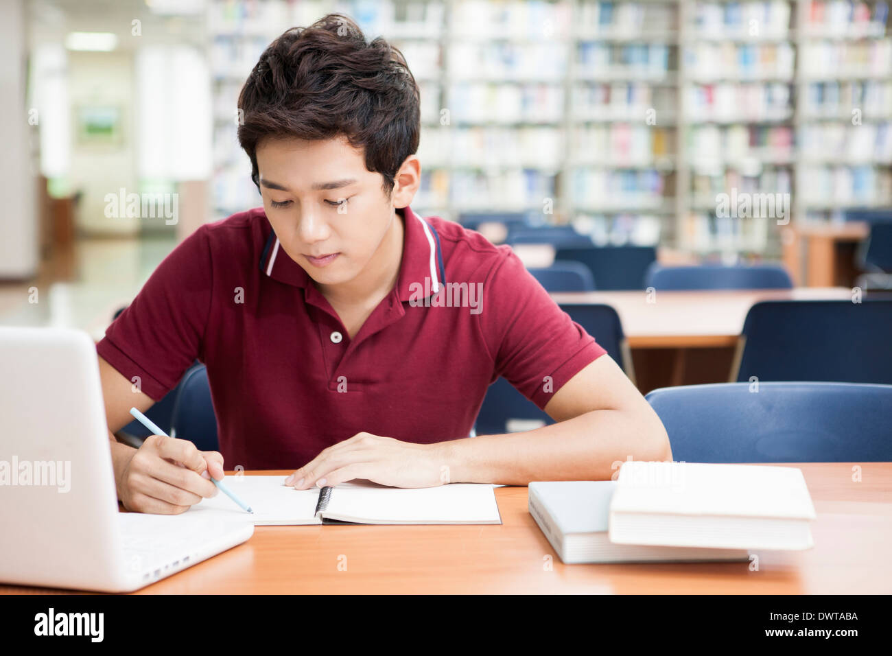 a boy studying in the library Stock Photo - Alamy