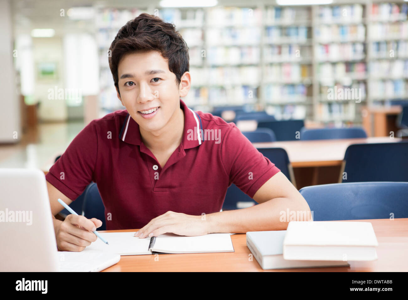 a boy studying in the library Stock Photo - Alamy