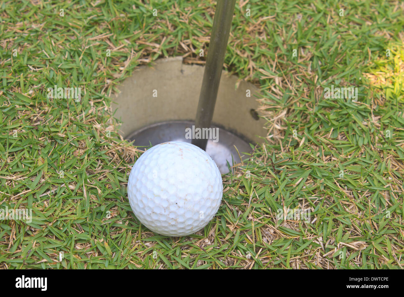 Blue golf ball at hole hi-res stock photography and images - Alamy