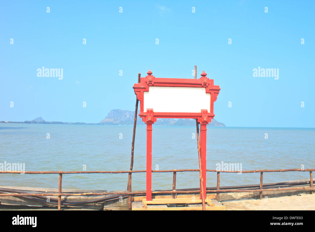 an image of a signpost situated against a wall at a sunny beach Stock ...