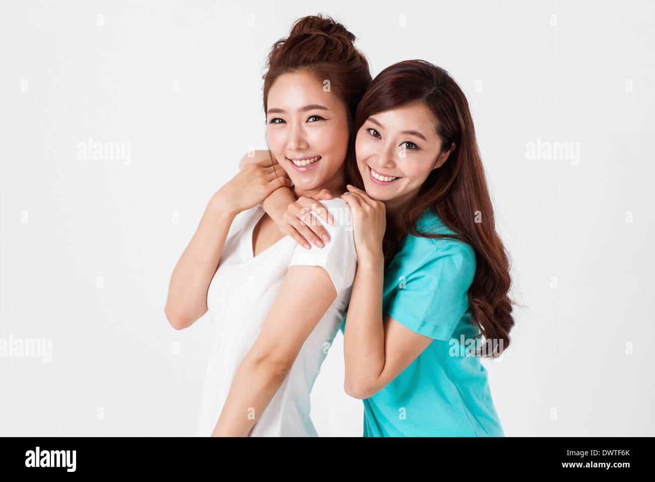 two women hugging and posing Stock Photo - Alamy