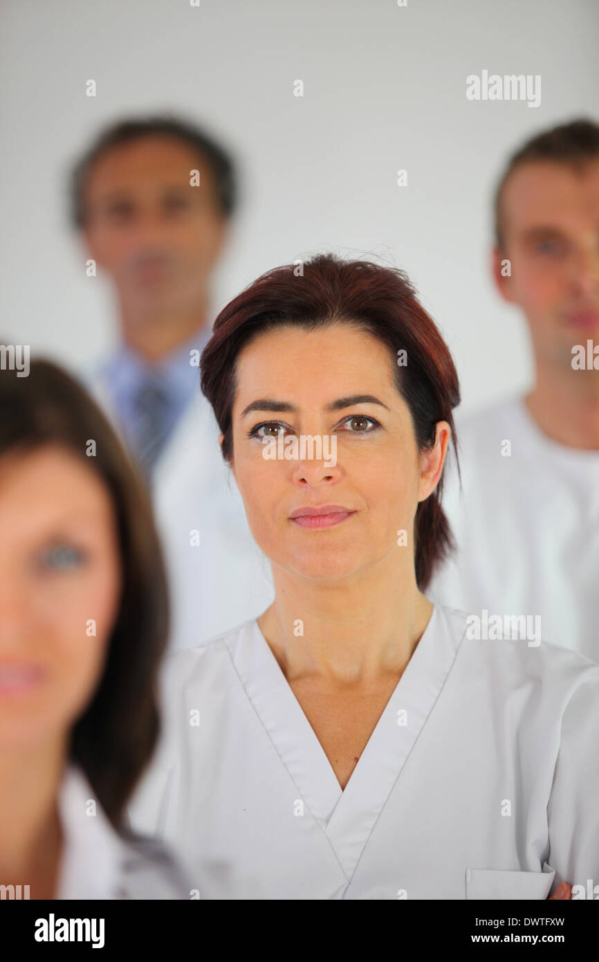 Nurse standing with colleagues Stock Photo - Alamy