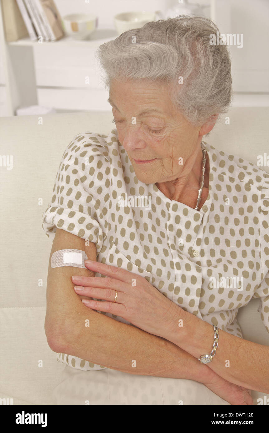 Band aid arm senior Stock Photo - Alamy