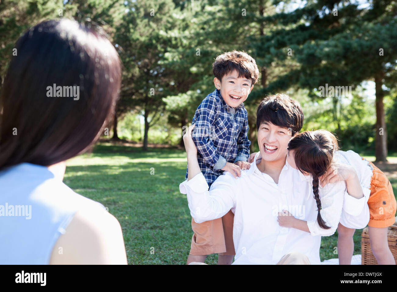 a father playing with kids in the nature Stock Photo - Alamy