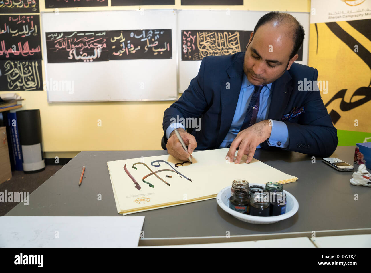 Calligrapher writing in ink at Calligraphy Museum in Sharjah, t Middle ...