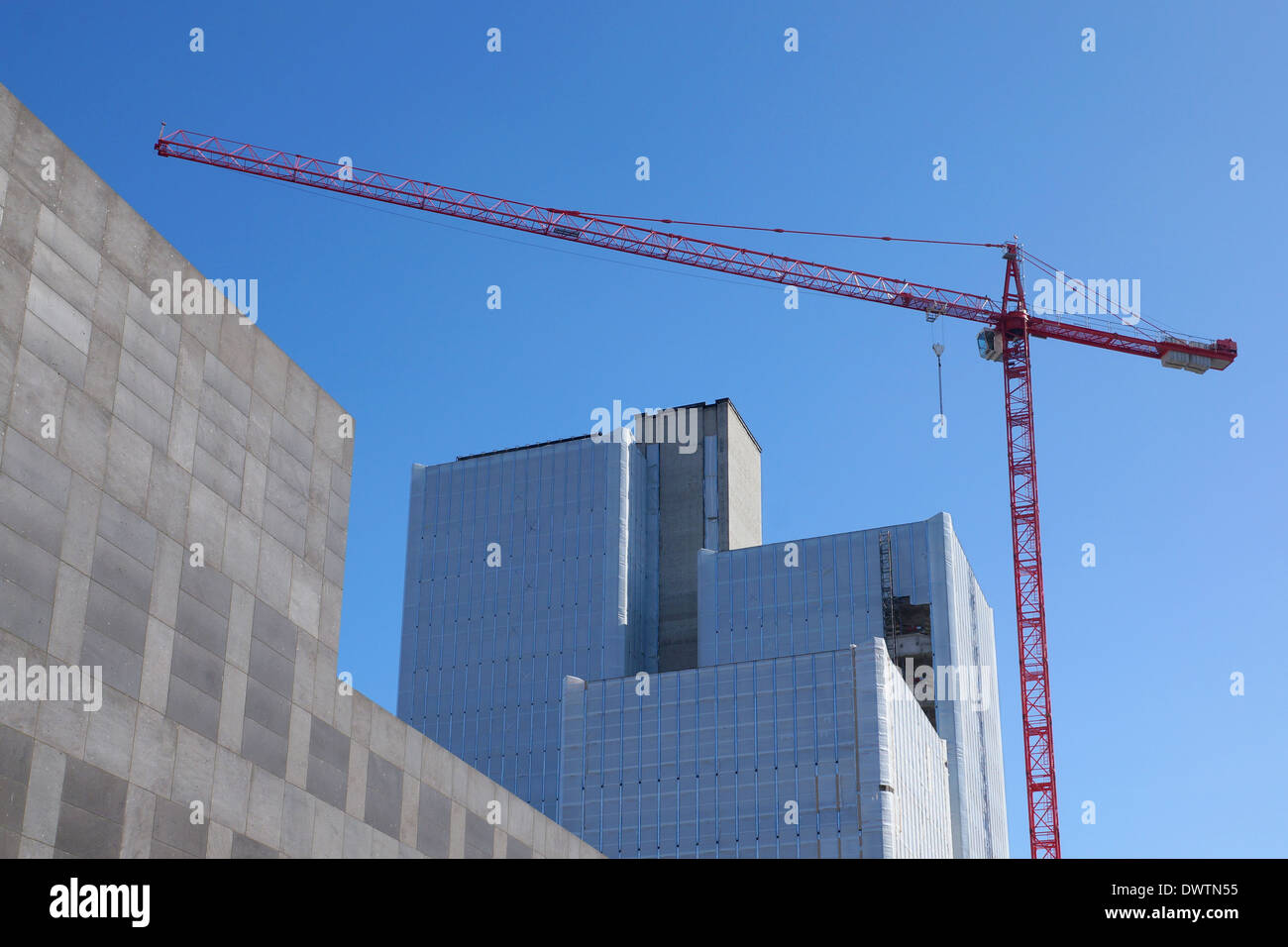 unfinished tower building with scaffolding and crane Stock Photo - Alamy