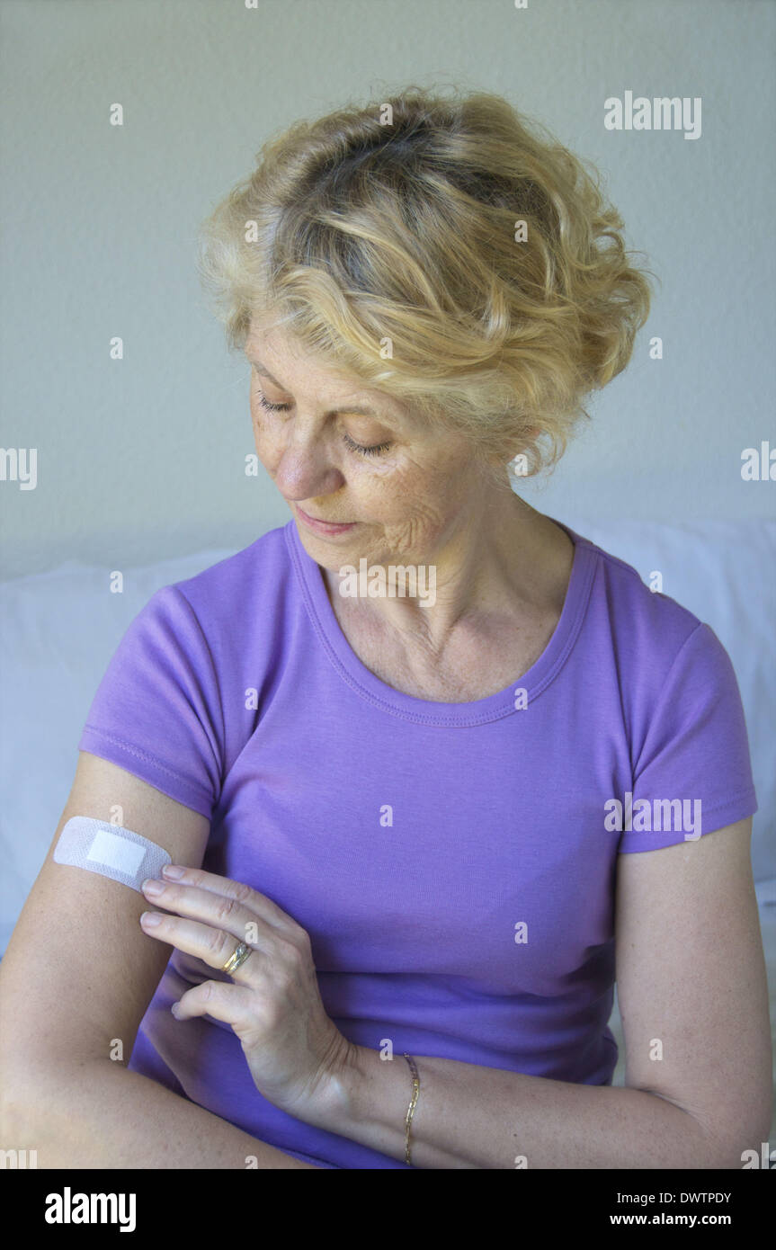 Band aid arm senior Stock Photo - Alamy