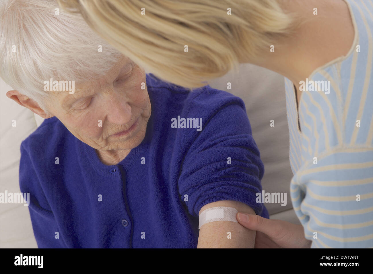 Band aid arm senior Stock Photo - Alamy