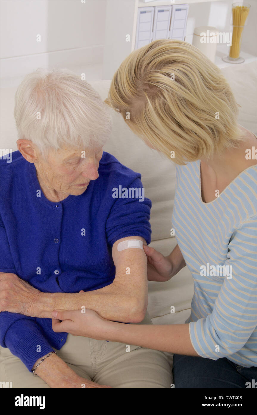 Band aid arm senior Stock Photo - Alamy