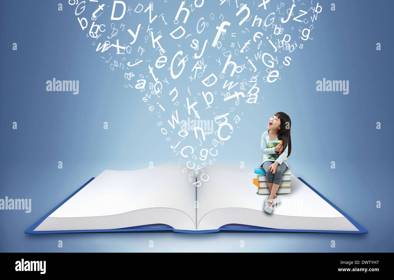 a girl sitting on a book Stock Photo - Alamy