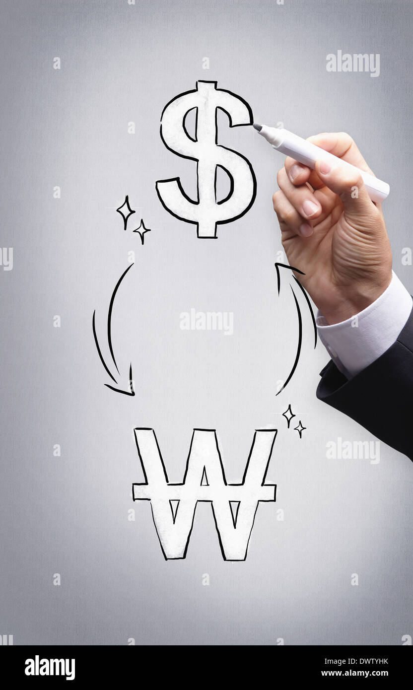 a business man writing currency signs Stock Photo - Alamy