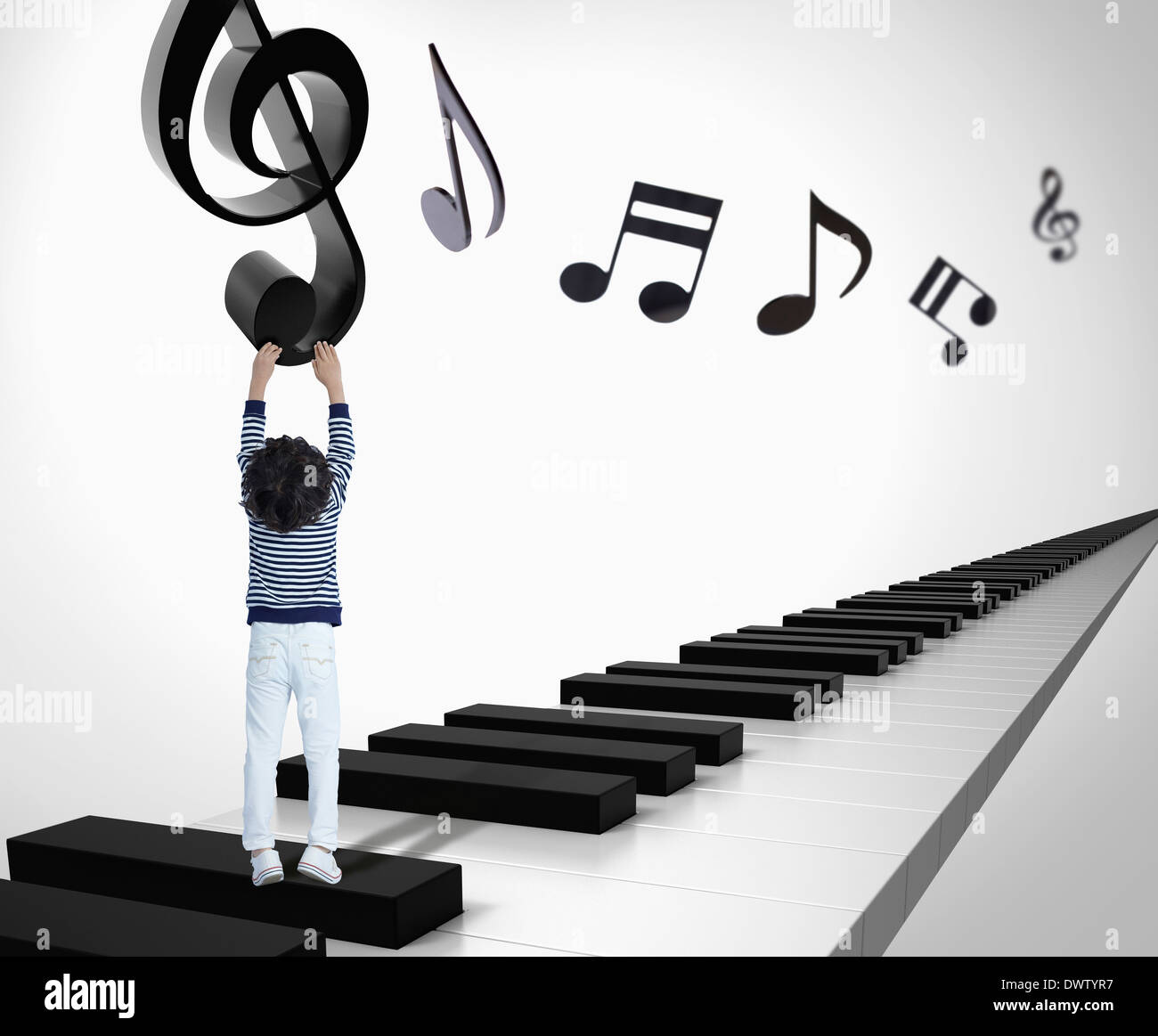 a boy standing on piano keys Stock Photo - Alamy