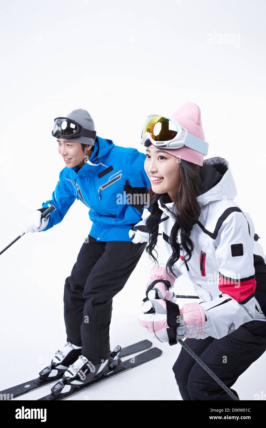 a couple wearing a pair of skis Stock Photo - Alamy