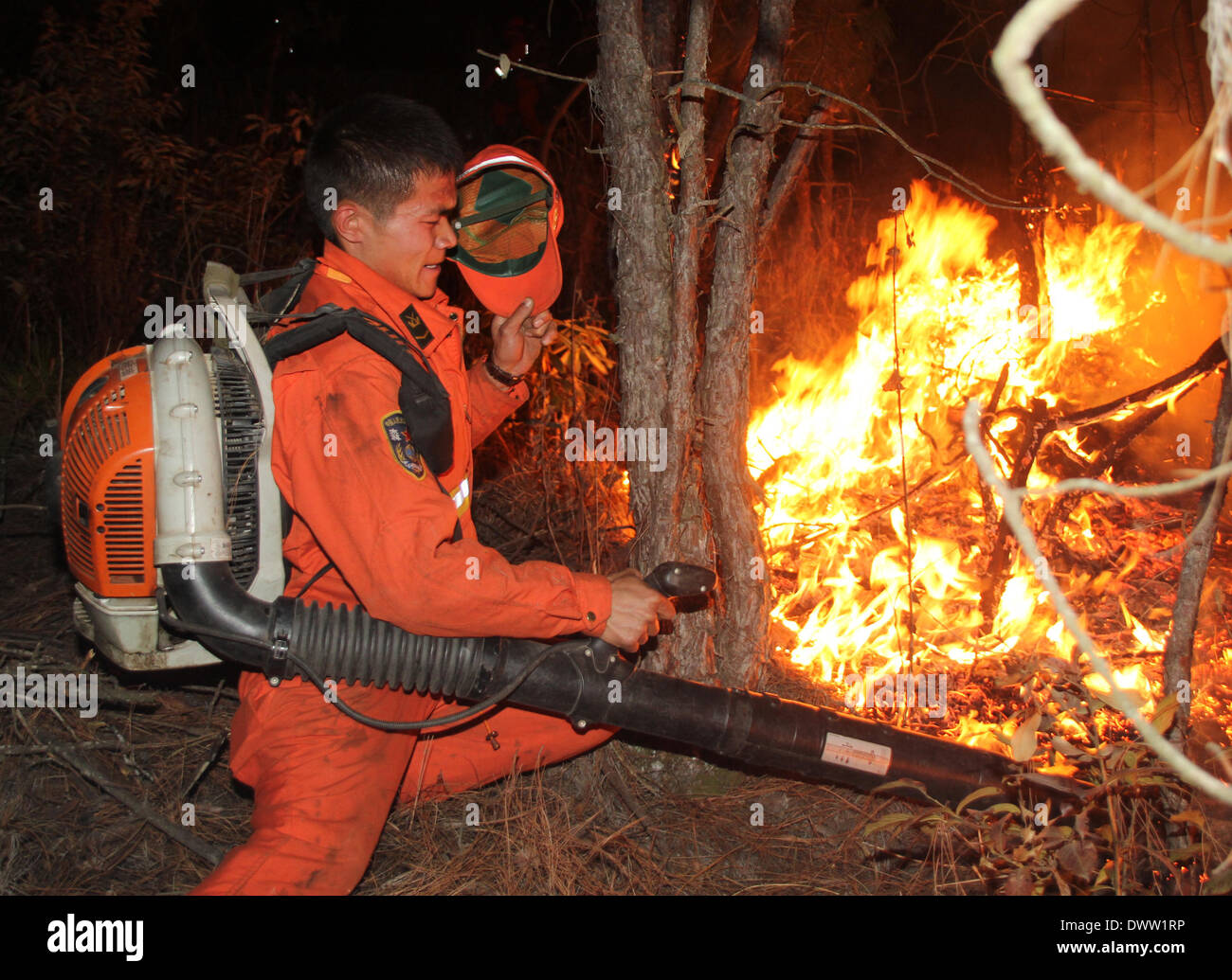 Lufeng county, Yunnan Province, China. 13 March 2014. A fireman tries ...