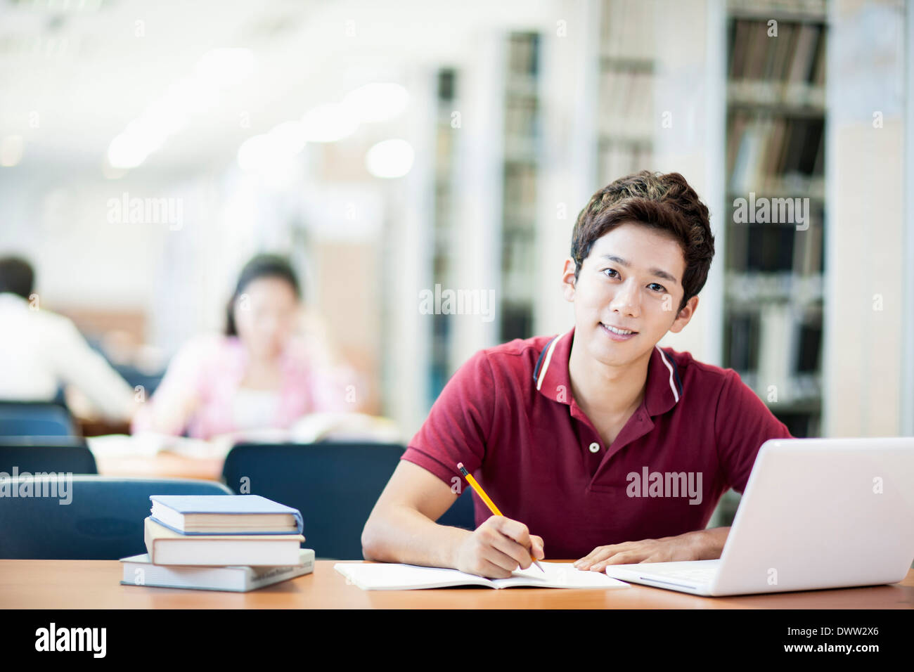 a boy studying in the library Stock Photo - Alamy