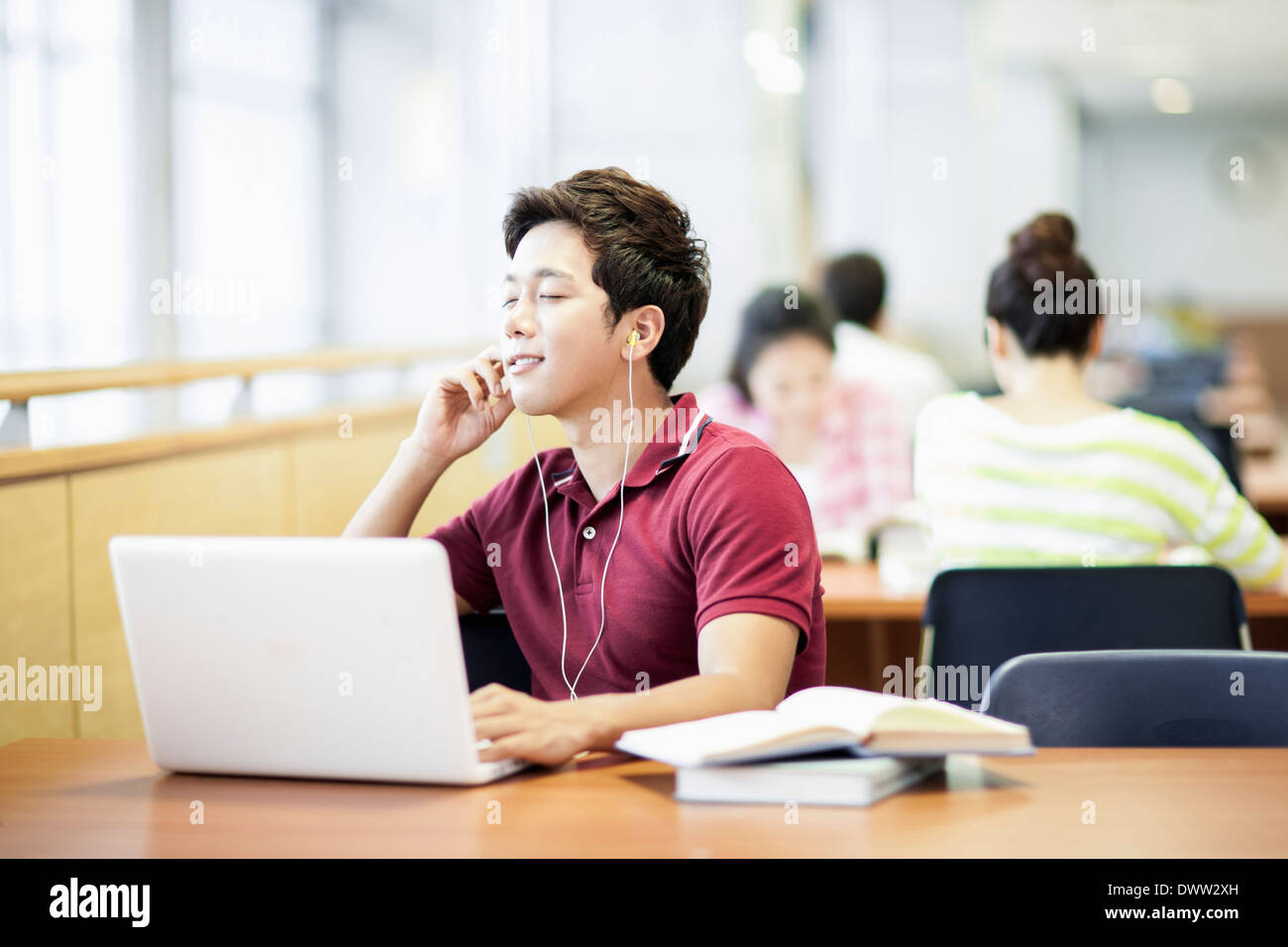 a boy studying in the library Stock Photo - Alamy