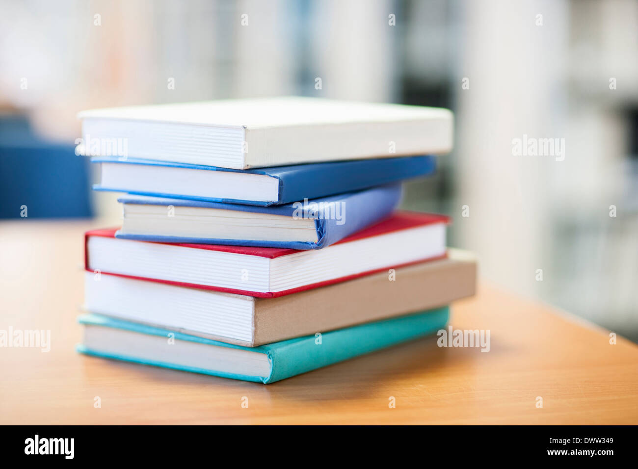 a pile of books in the library Stock Photo - Alamy