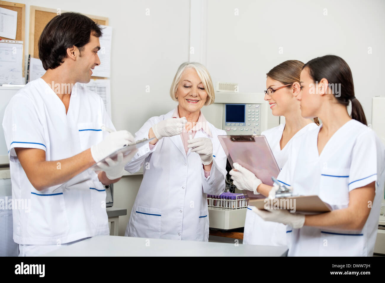 Scientists Discussing Over Sample In Laboratory Stock Photo - Alamy