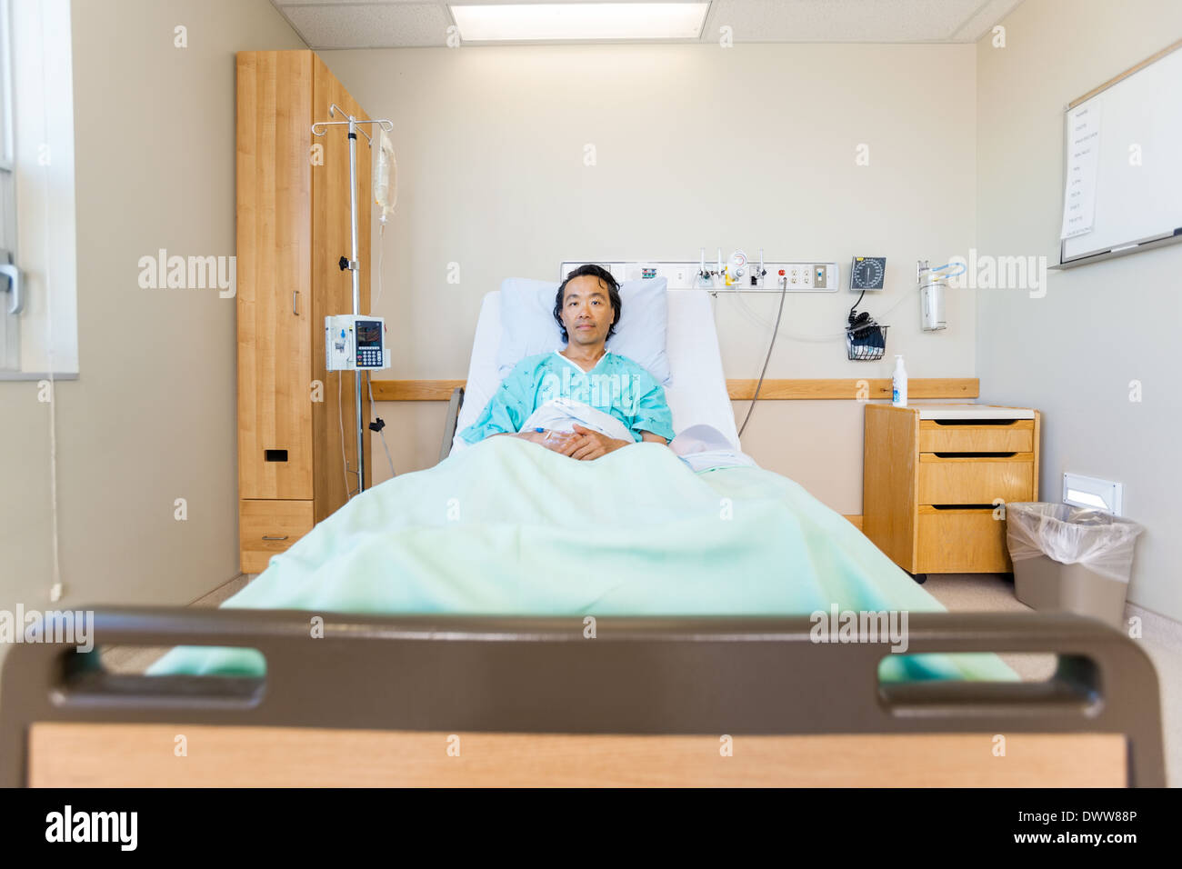 Portrait Of Male Patient Reclining On Hospital Bed Stock Photo - Alamy