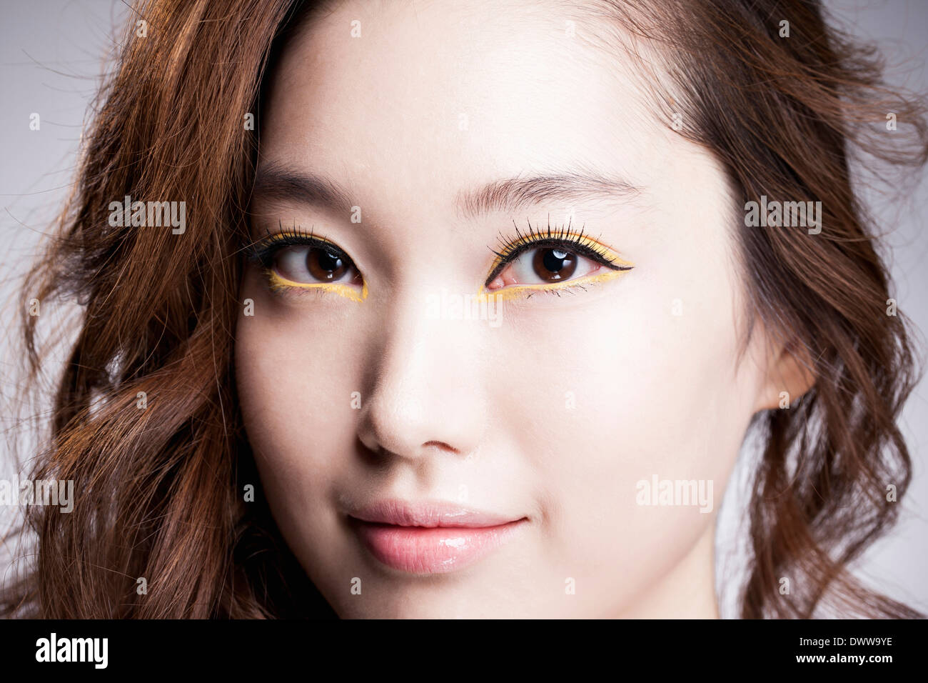 a woman with yellow make up in the eyes Stock Photo - Alamy