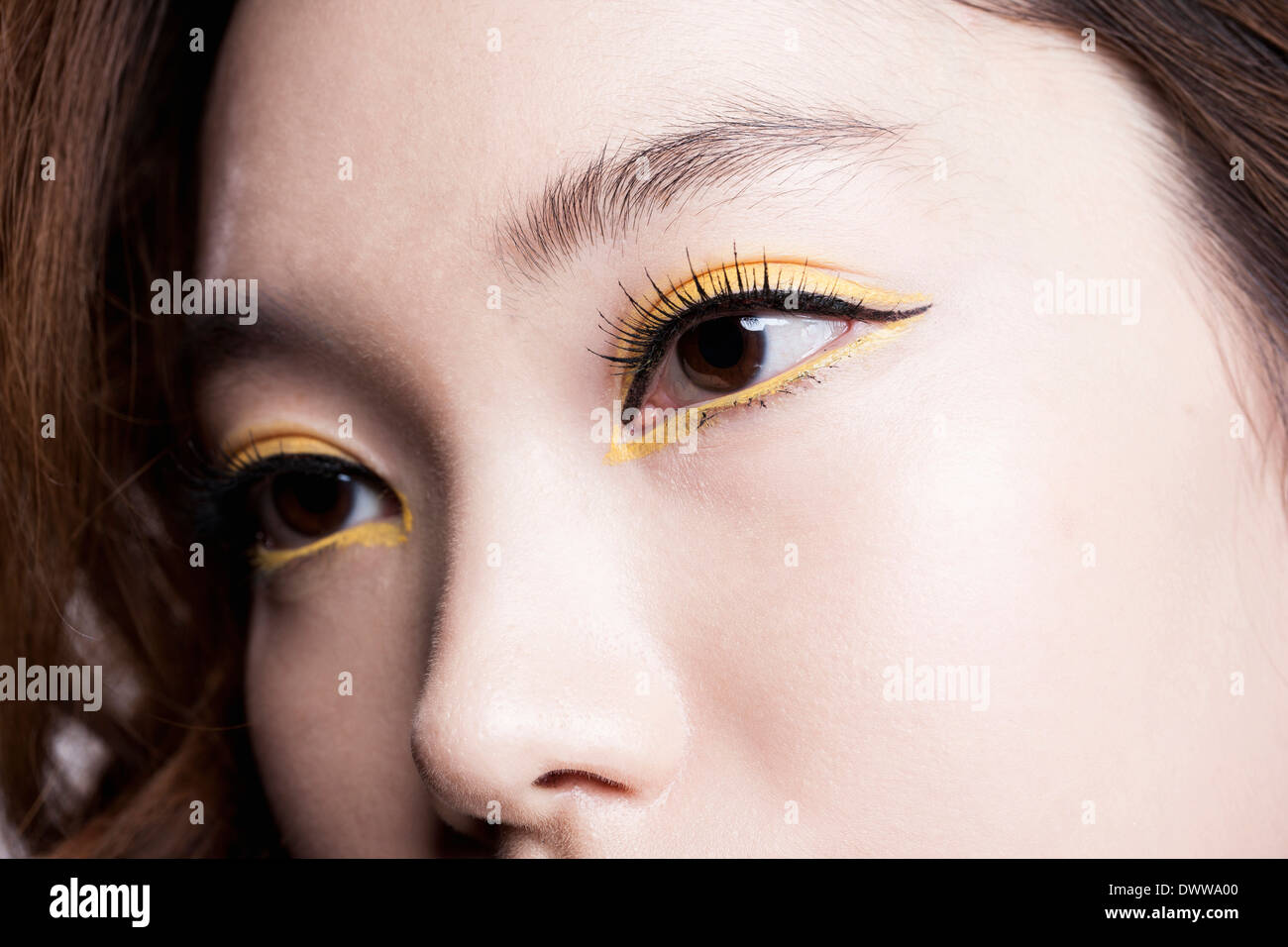 a woman with yellow make up in the eyes Stock Photo - Alamy