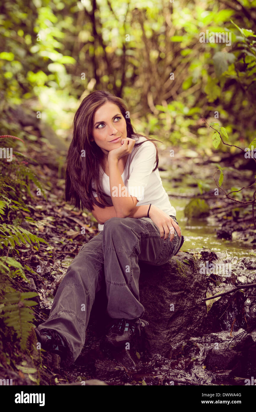 Portrait. Girl in the woods thinking Stock Photo - Alamy